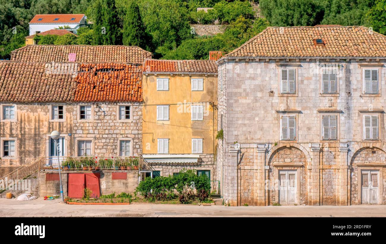 Traditional stone homes along the waterfront street in the picturesque ...