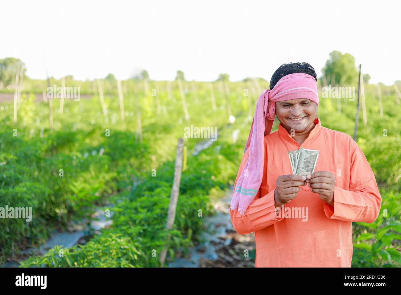 Happy Indian farmer, farmer holding indian rupees in hands, smart ...