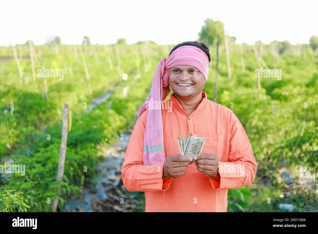 Happy Indian farmer, farmer holding indian rupees in hands, smart ...