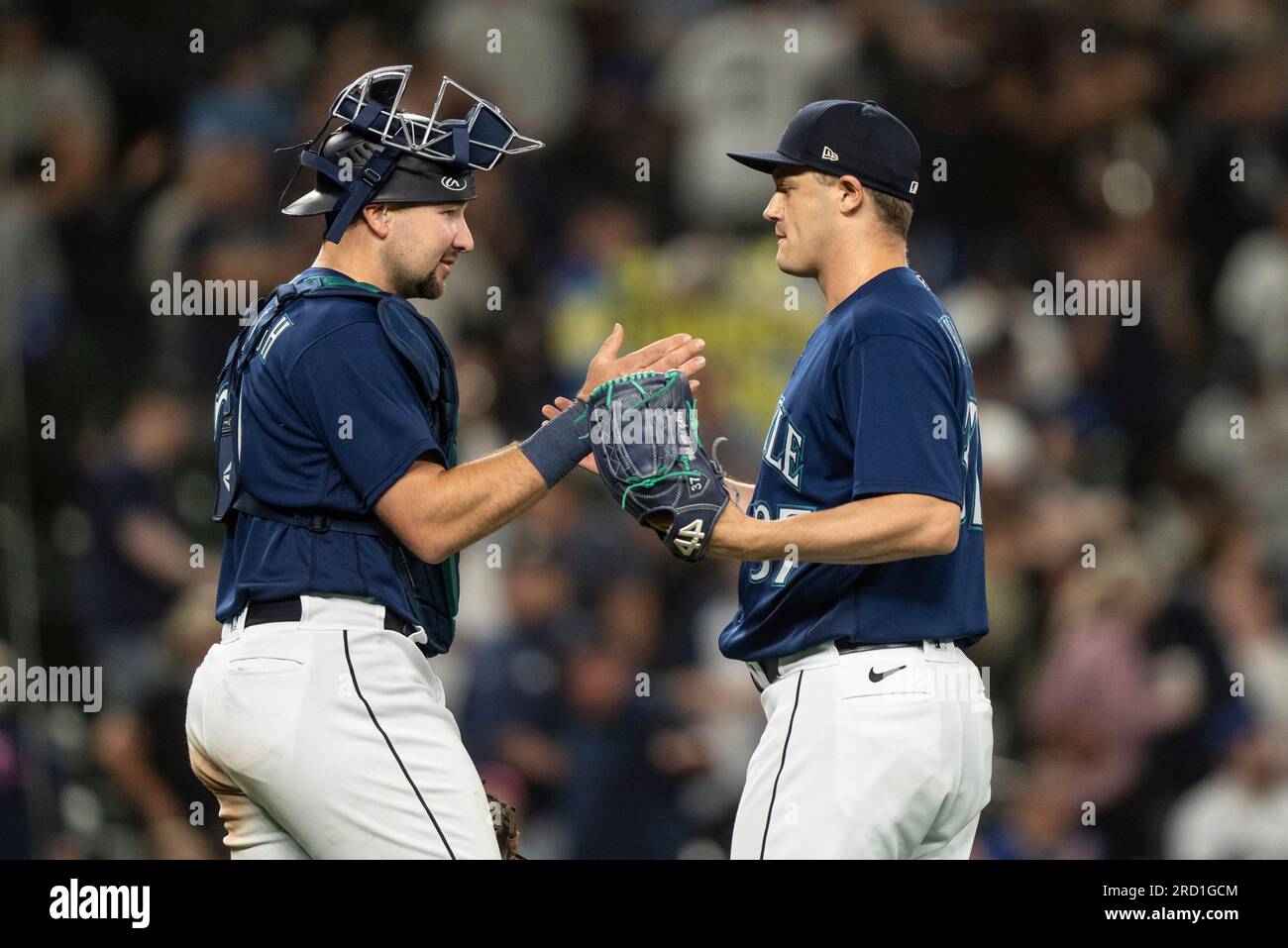 Seattle Mariners catcher Cal Raleigh, left, and relief pitcher Paul ...
