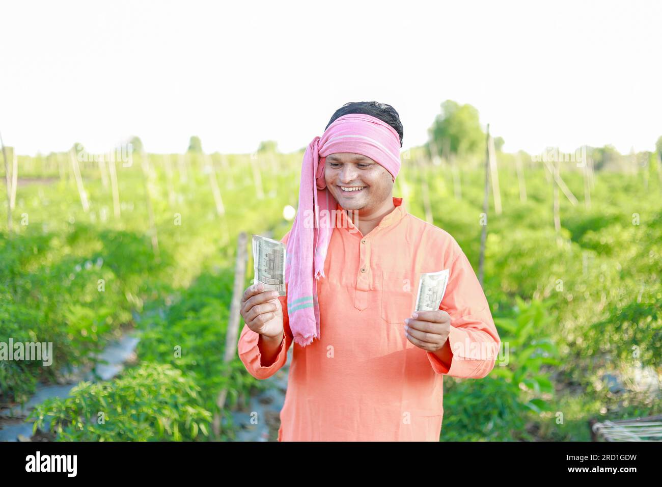 Happy Indian farmer, farmer holding indian rupees in hands, smart ...