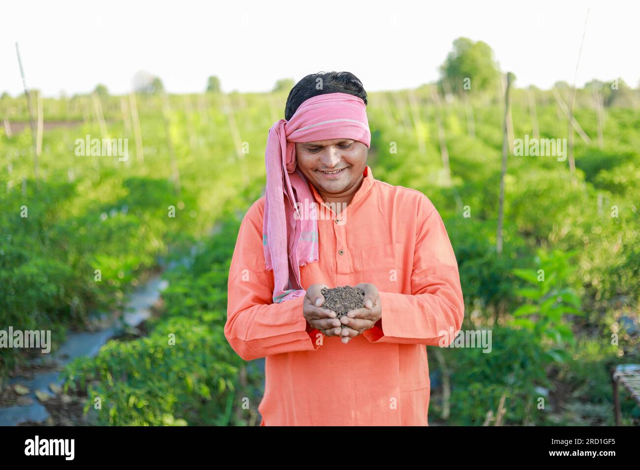 Happy Indian farmer, farmer holding soil in hands Stock Photo - Alamy
