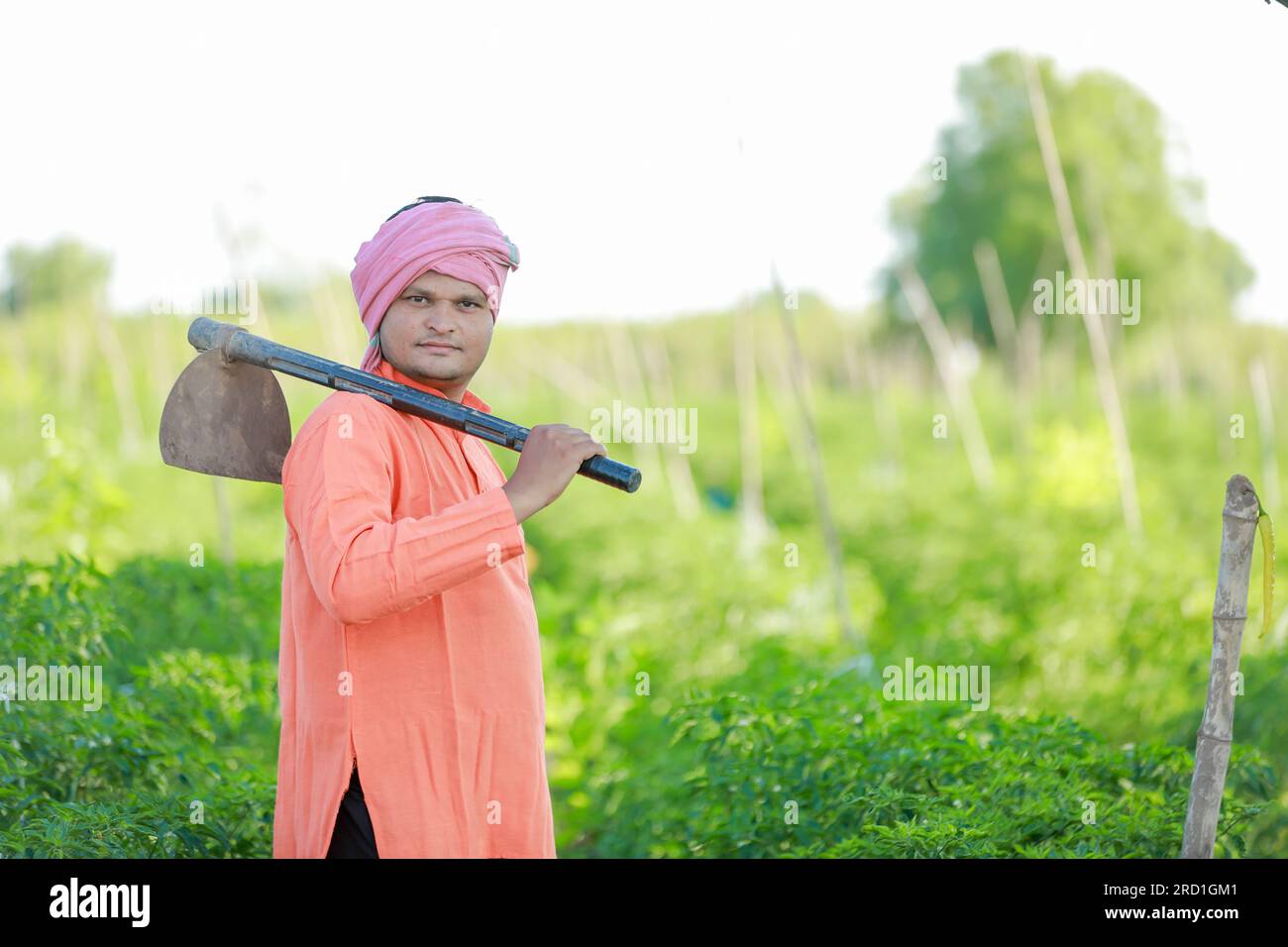 Happy Indian farmer, holding farming tools in hand Stock Photo - Alamy