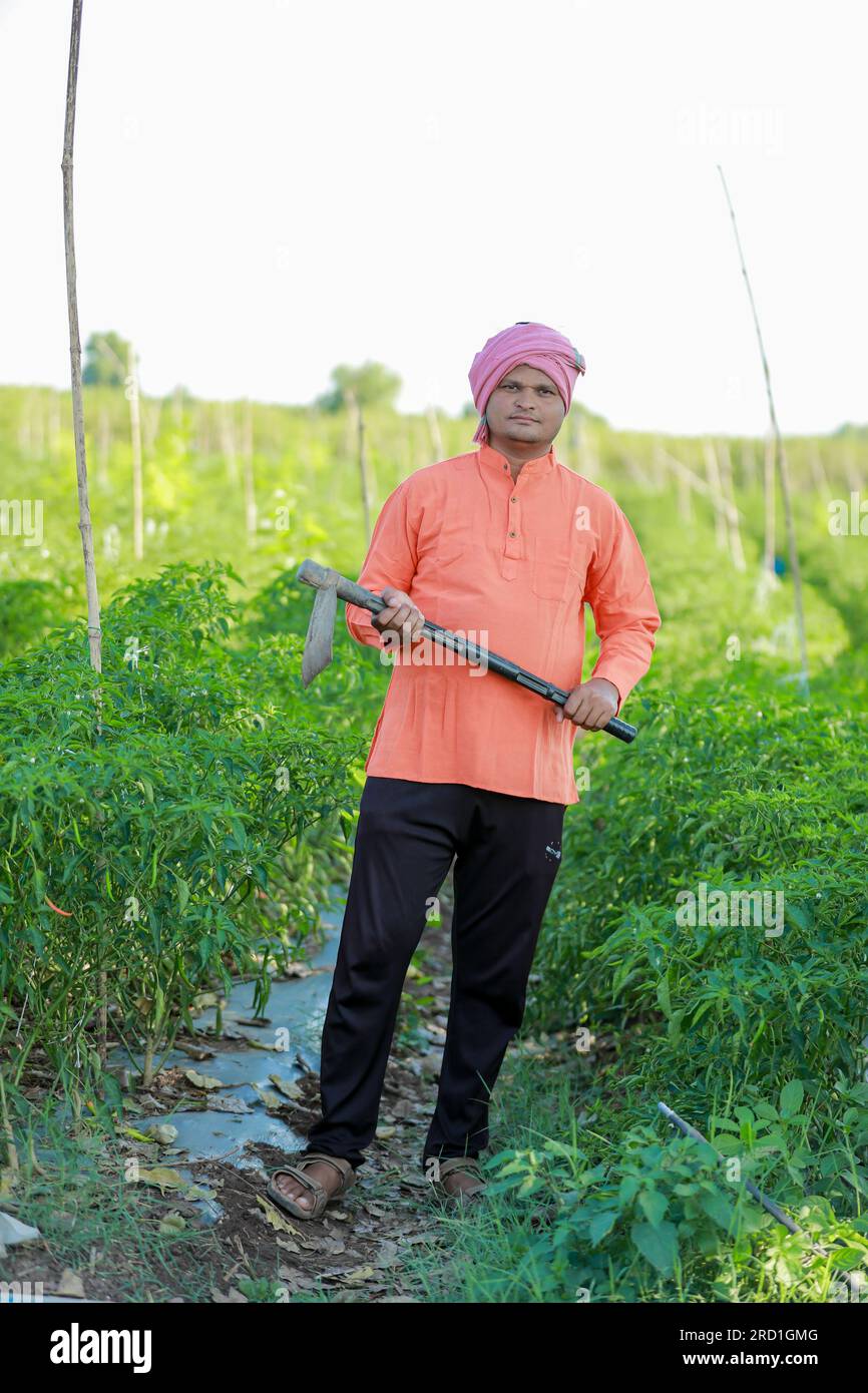 Happy Indian farmer, holding farming tools in hand Stock Photo - Alamy