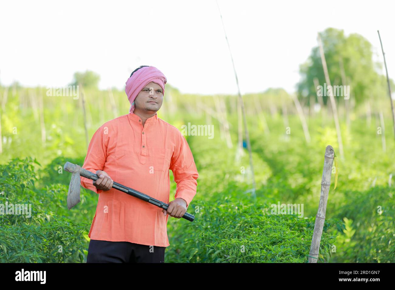 Happy Indian farmer, holding farming tools in hand Stock Photo - Alamy