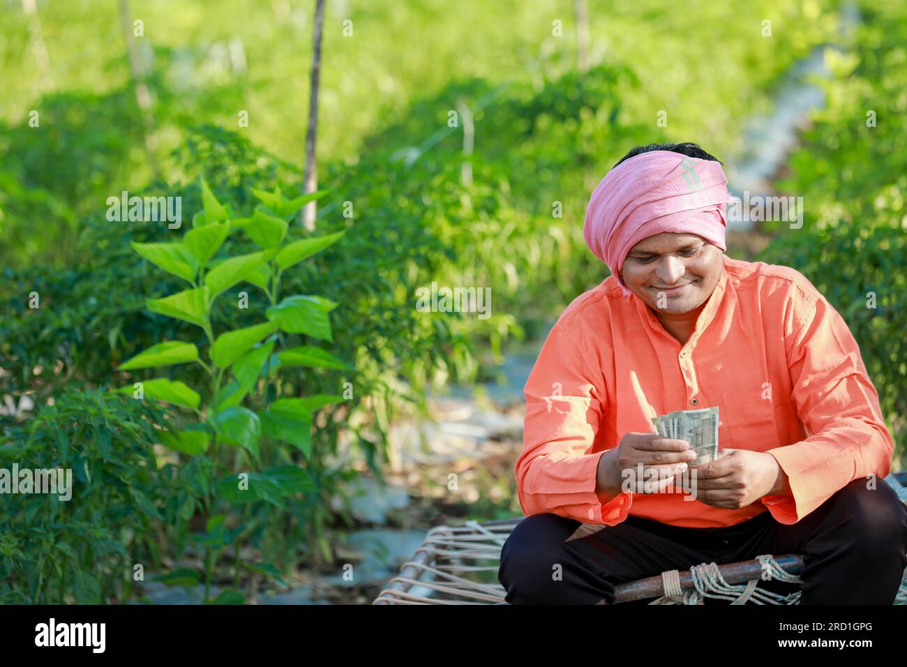 Happy Indian farmer, farmer holding indian rupees in hands, smart ...