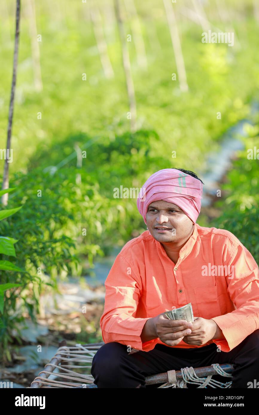 Happy Indian farmer, farmer holding indian rupees in hands, smart ...