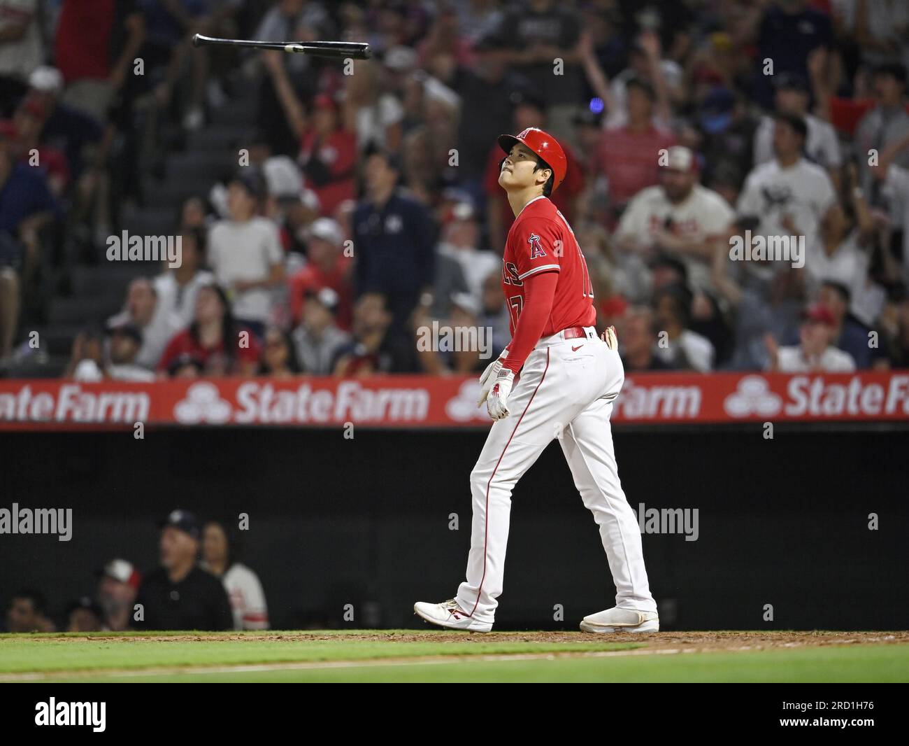 Shohei Ohtani of the Los Angeles Angels flips his bat in the air after ...