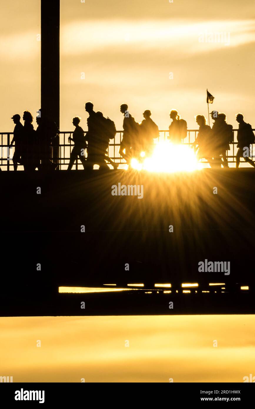 NIJMEGEN - Runners walk across the Waal Bridge on the first day of the ...