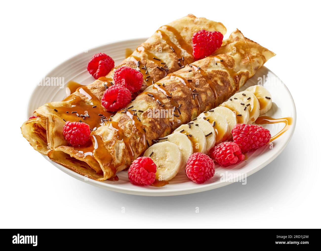 plate of freshly baked crepes decorated with caramel sauce and fruits ...