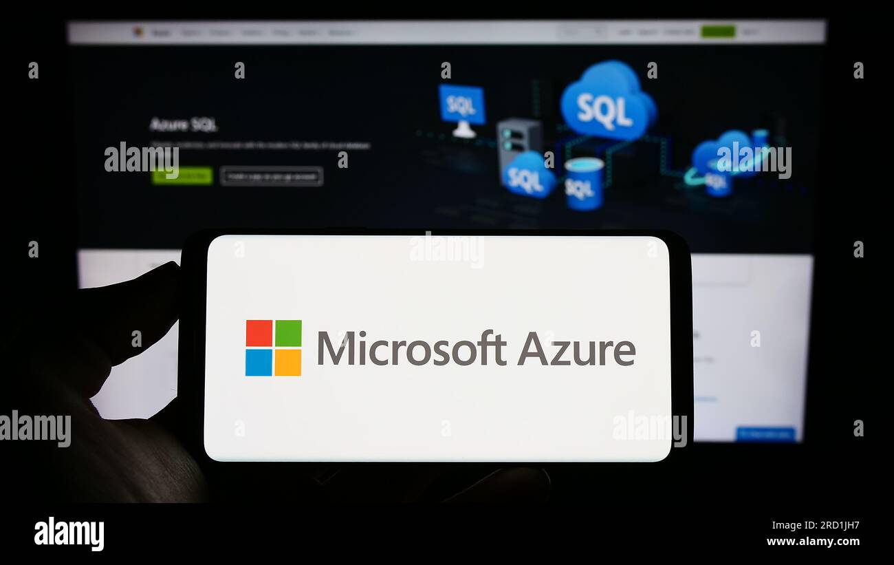 Person holding cellphone with logo of cloud computing platform ...