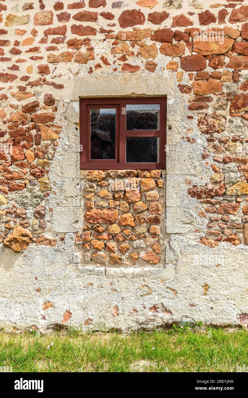 Blocked doorway detail of traditional red stone building materials used ...