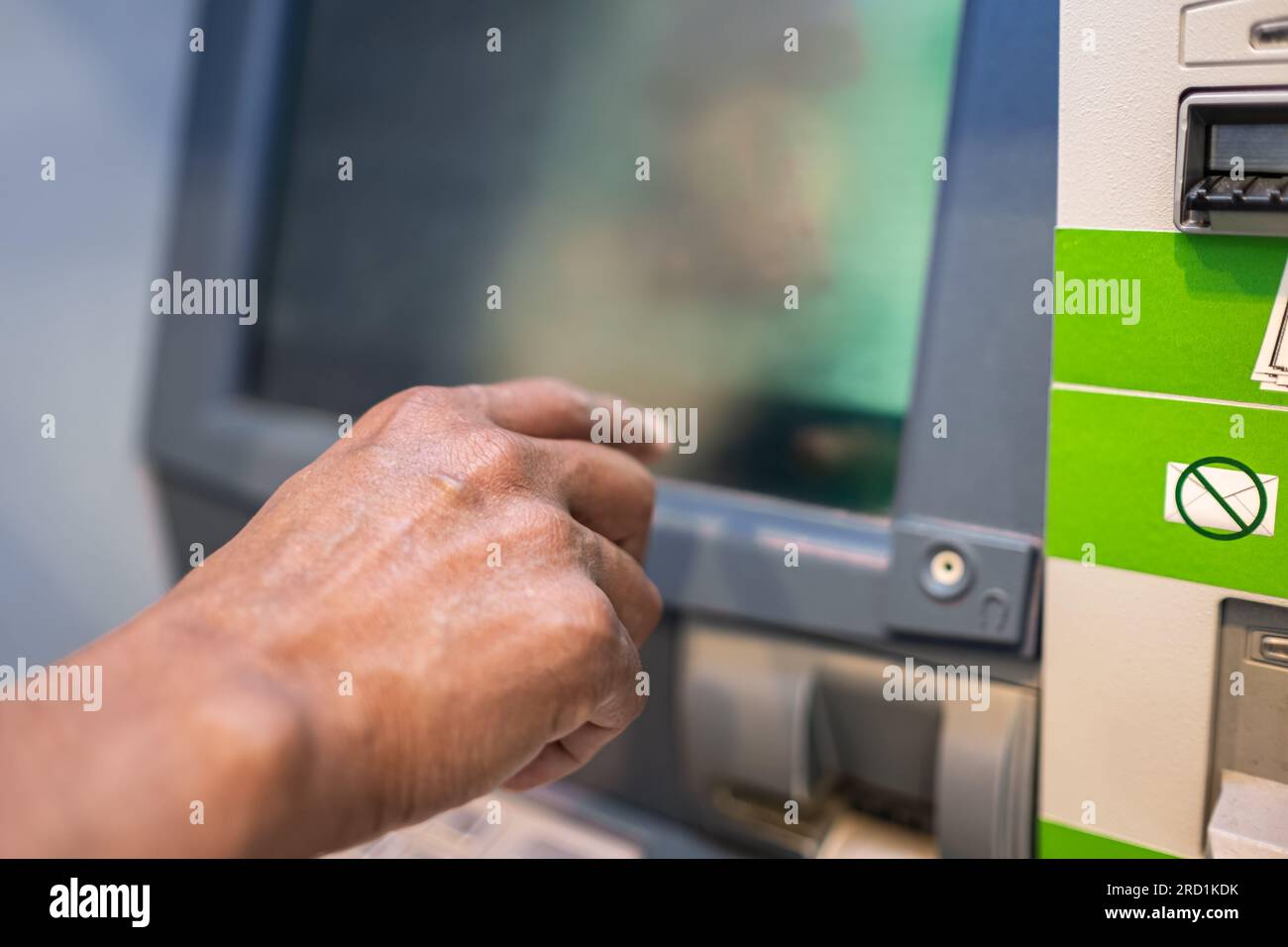 Closeup of male hands using smart phone while typing on ATM, bank ... Closeup of male hands using smart phone while typing on ATM, bank ...