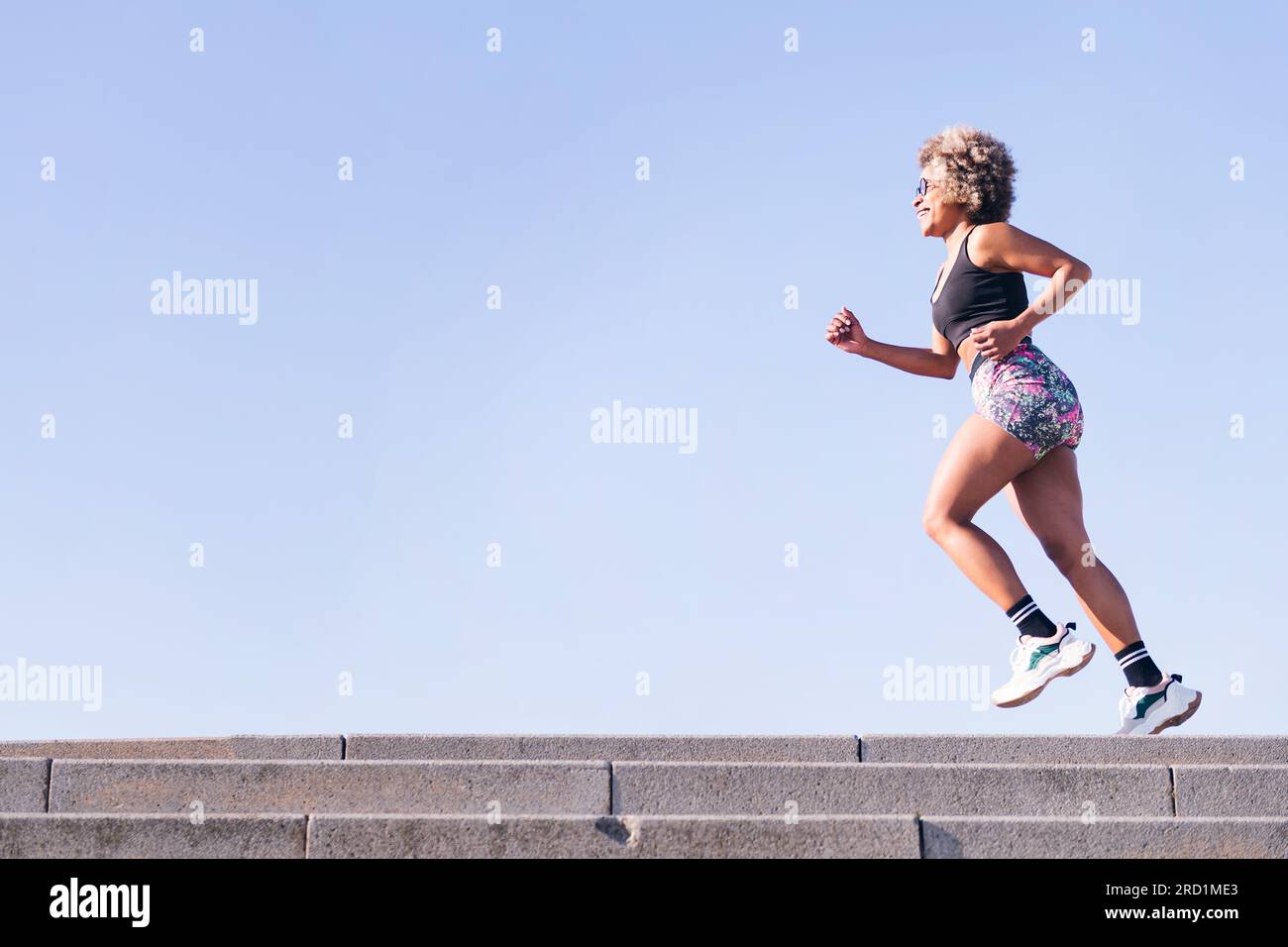 happy african american woman running outdoors Stock Photo - Alamy