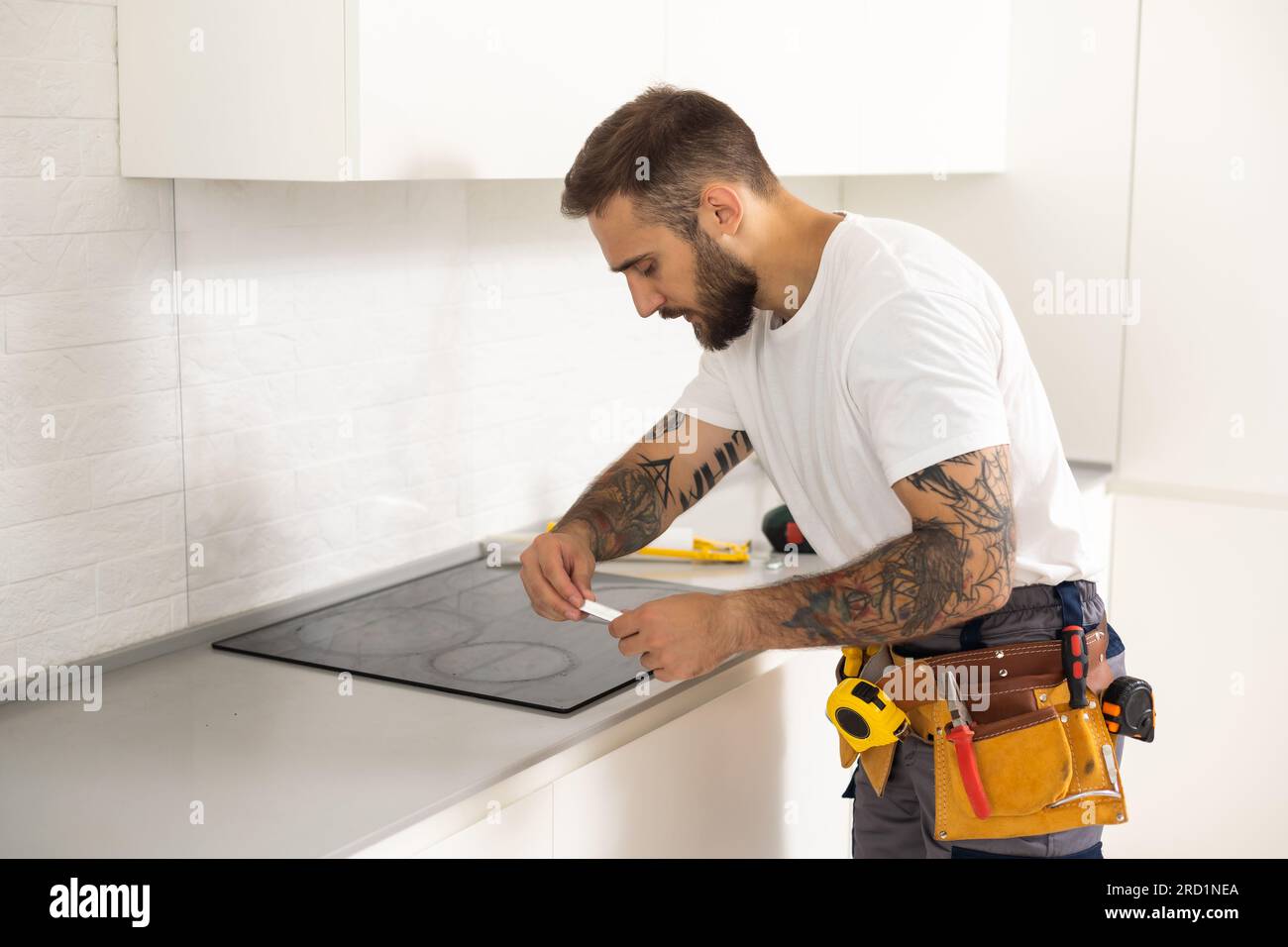 craftsman installs hob in kitchen. Household Appliance Installation ...