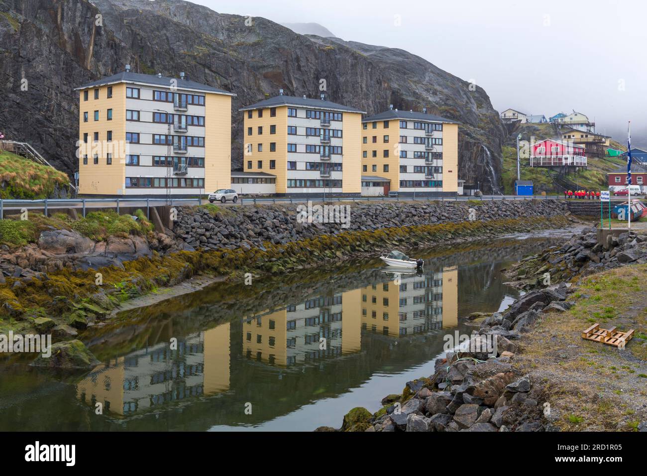 Residential apartments reflected in water at Maniitsoq (also known as ...