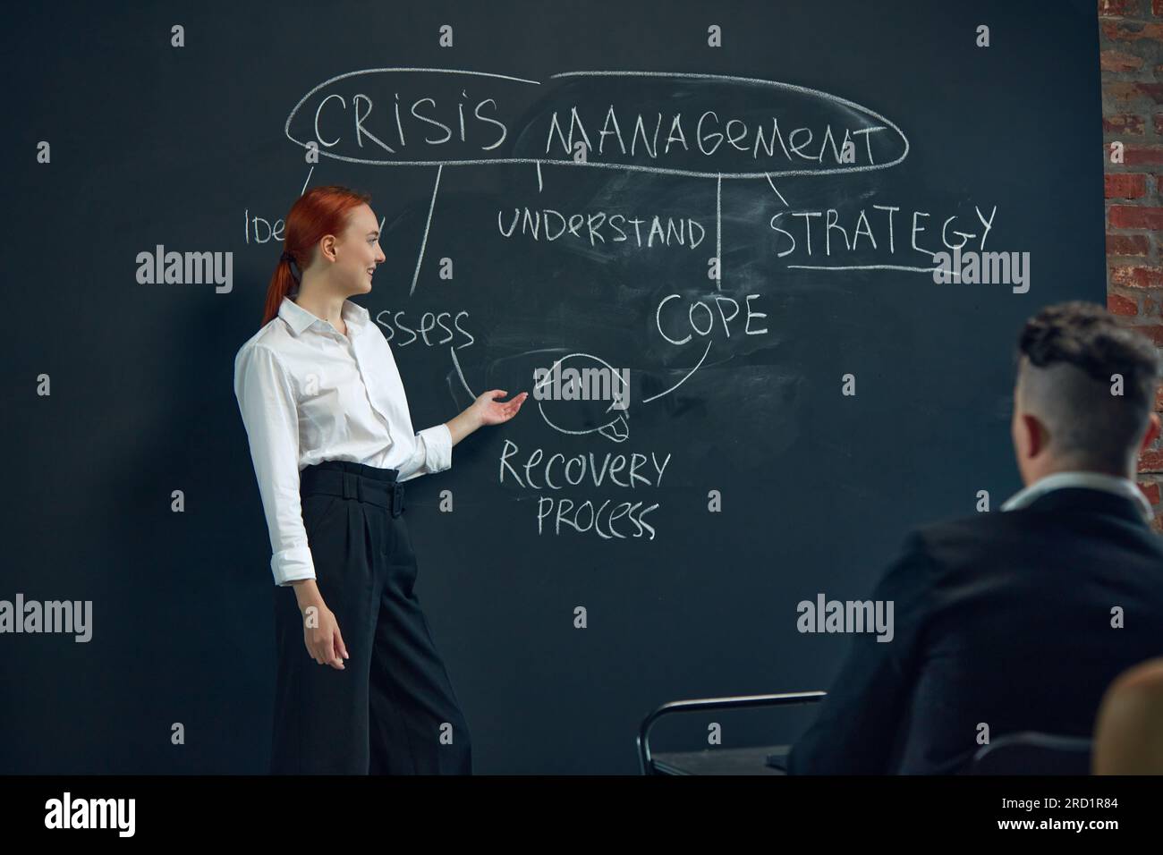 Woman employee writing on blackboard hi-res stock photography and ...