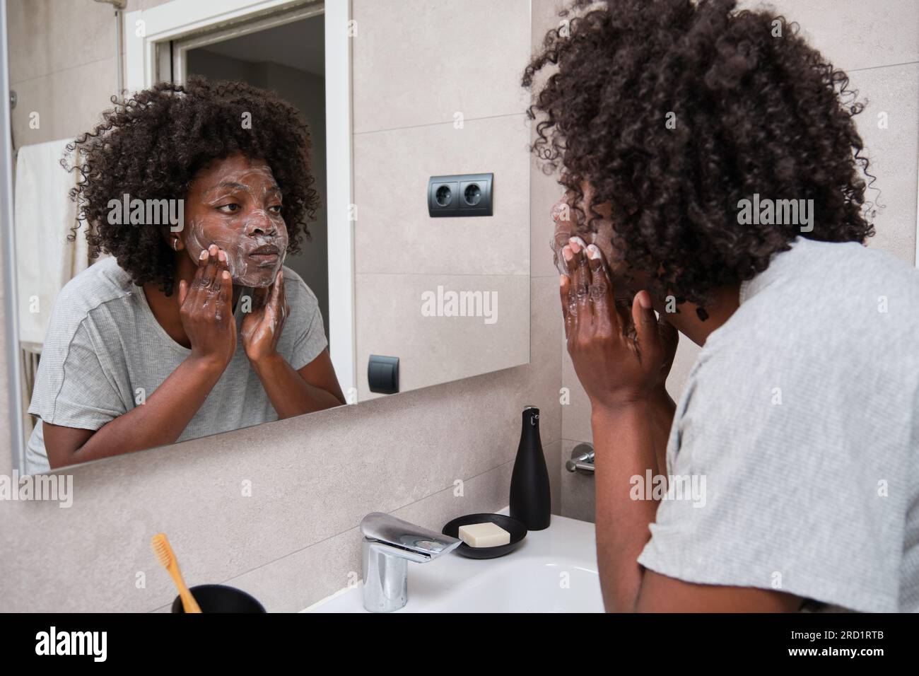 African woman maintains her beauty with daily face washing routine ...