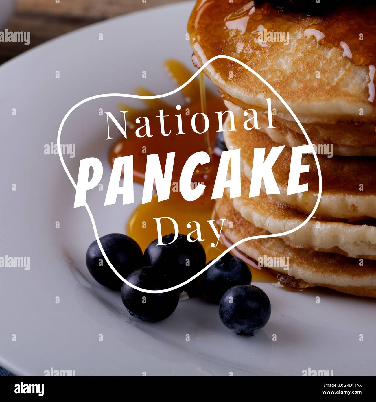 Enjoy national pancake day text in white over pancake stack on plate ...