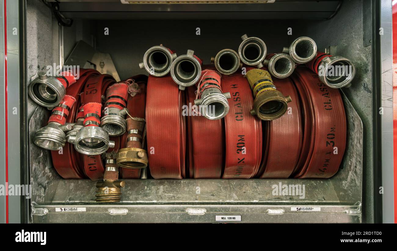 Closeup of firefighting hoses rolled up in storage Stock Photo - Alamy