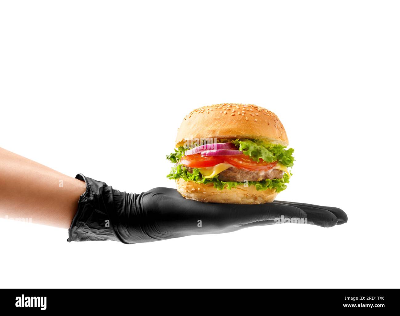 A hand in a black glove holds a juicy, appetizing beef burger on a ...
