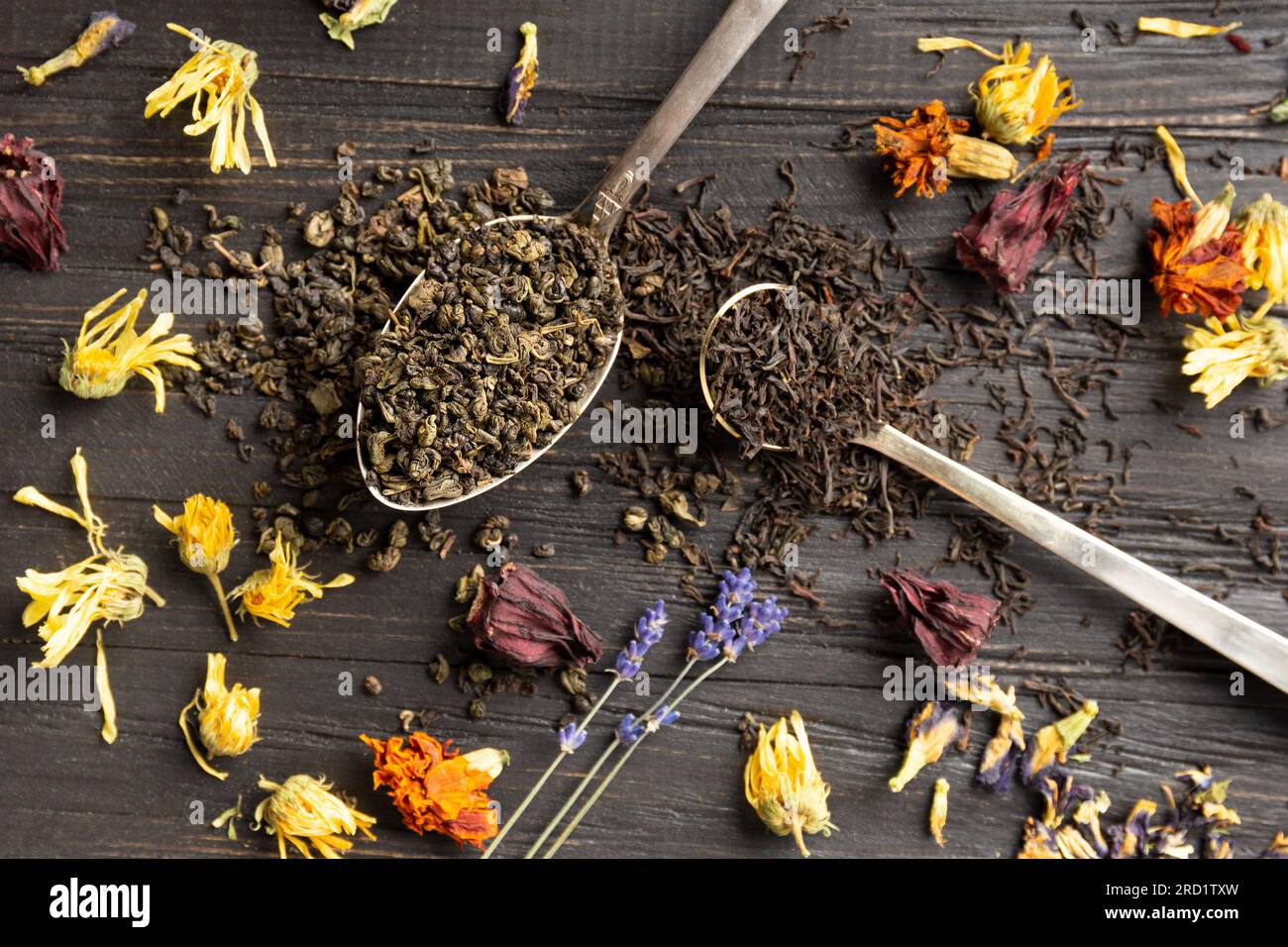 Composition of dry black and green tea in vintage spoons and dry ...