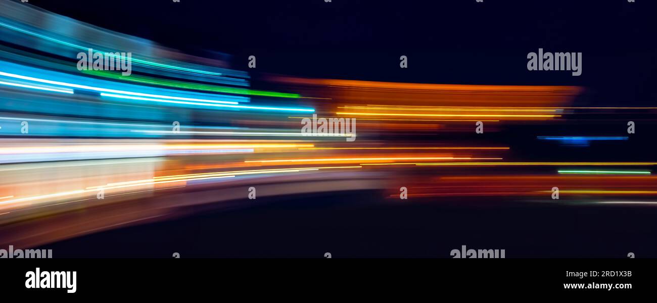 Abstract Rainbow light trails on the dark background Stock Photo - Alamy