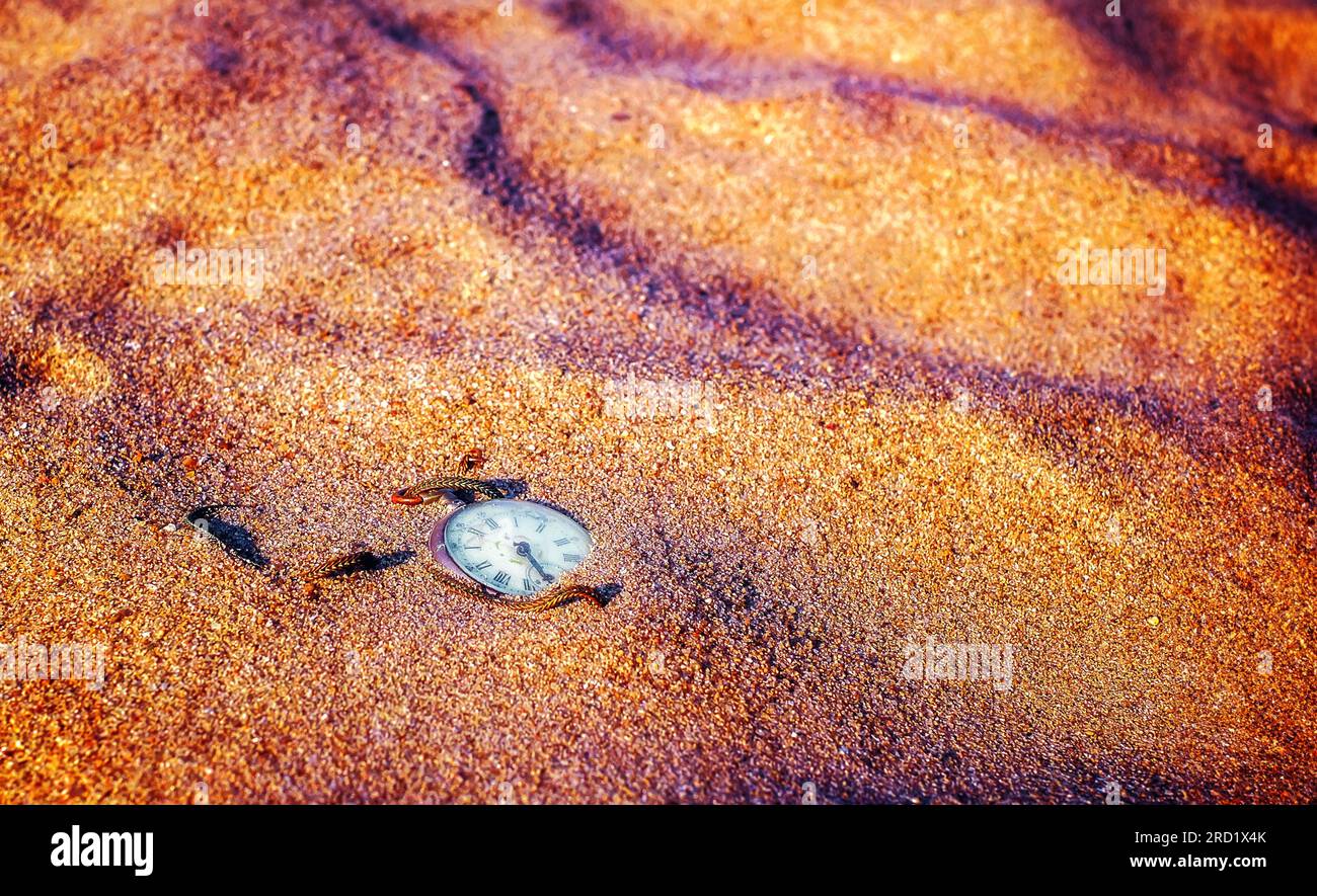 Antique rotten pocket watch buried partial in the sand Stock Photo - Alamy
