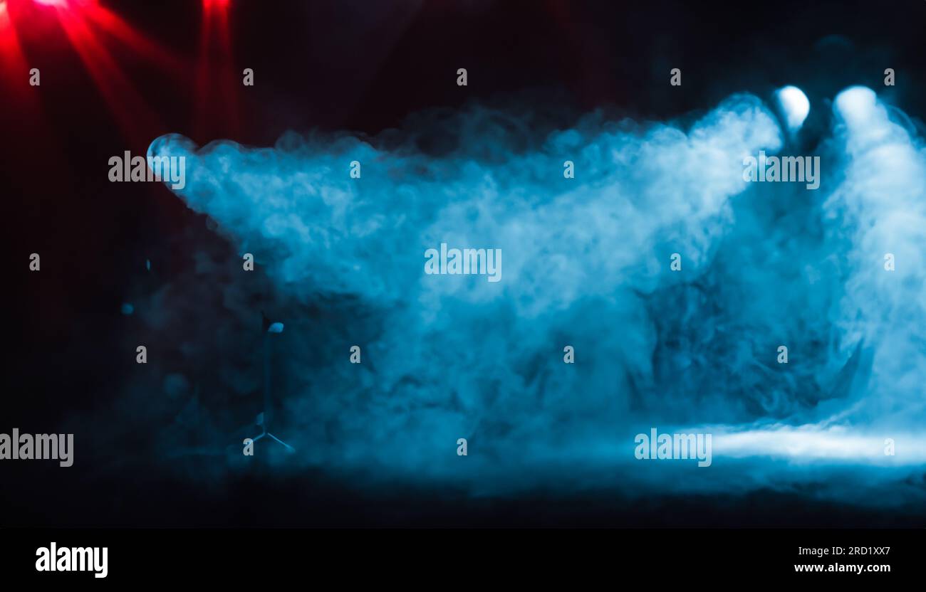 projectors light beam through smoke on stage Stock Photo - Alamy