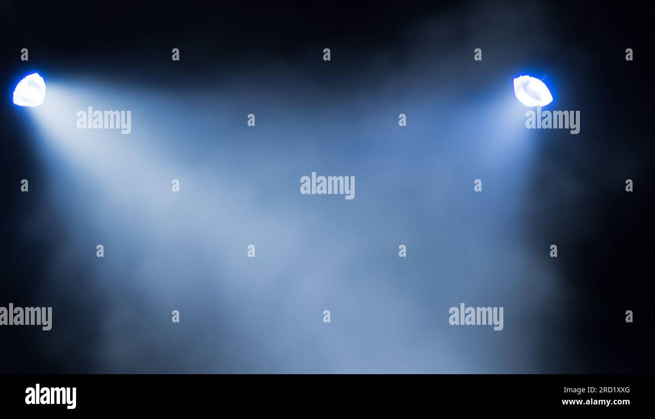projectors light beam through smoke on stage Stock Photo - Alamy