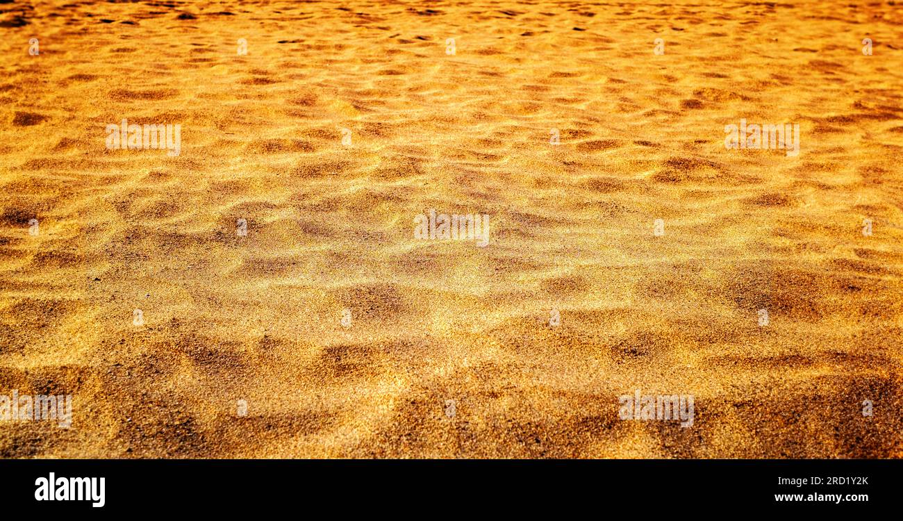 Sunset on the beach. Sand texture Stock Photo - Alamy
