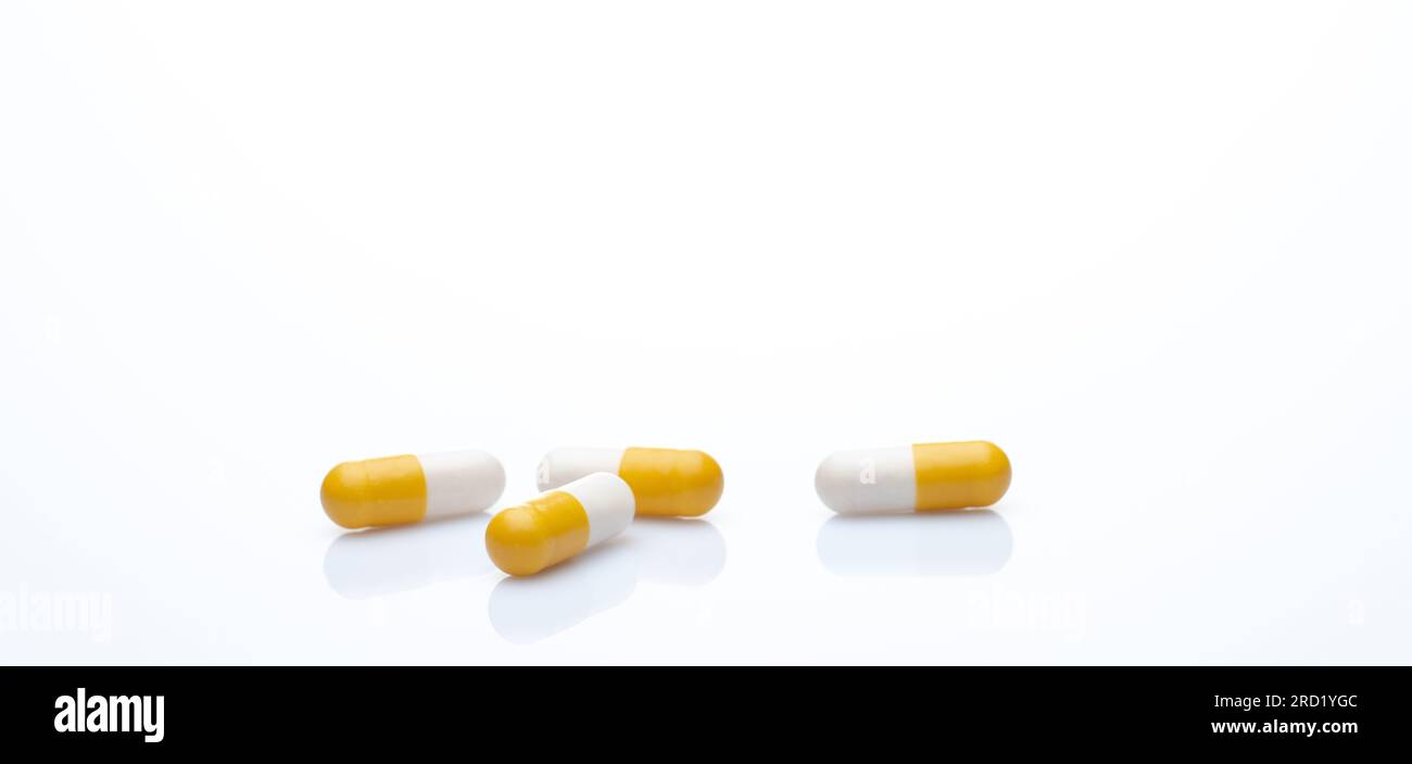 Yellow-white probiotic capsule pill on white background. Probiotic ...