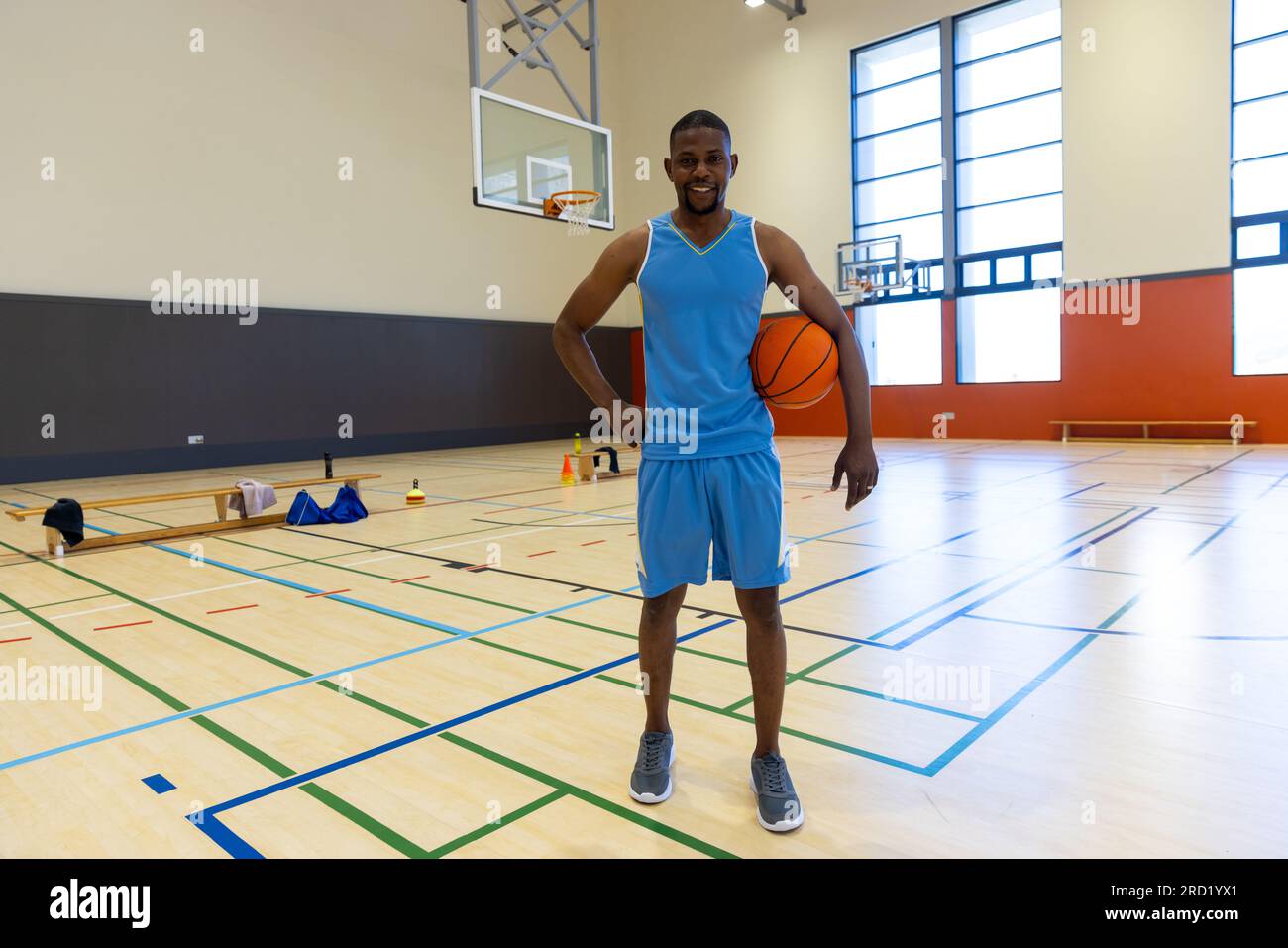 Portrait of happy african american male basketball player wearing blue ...
