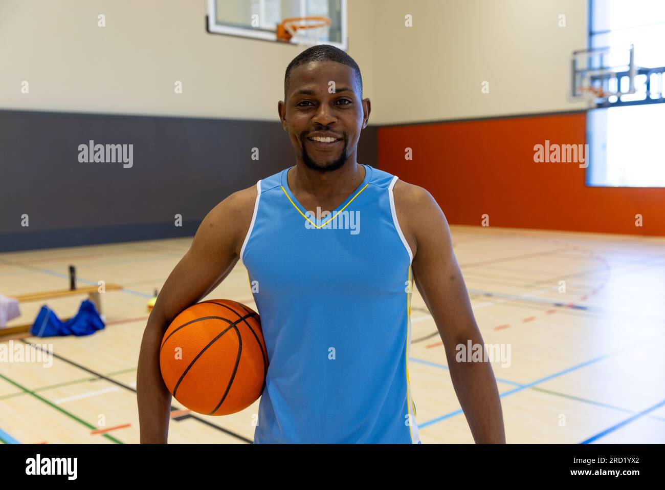 Portrait of happy african american male basketball player wearing blue ...