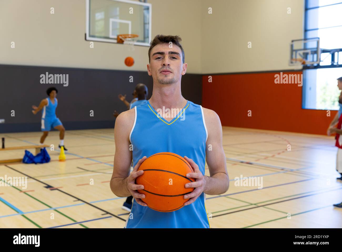 Portrait of happy caucasian male basketball player wearing blue sports ...