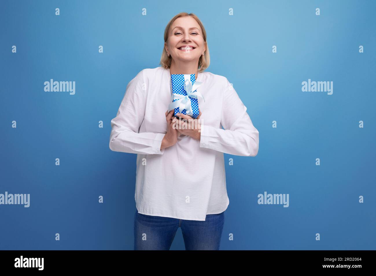happy 50s woman received a gift on studio background Stock Photo - Alamy