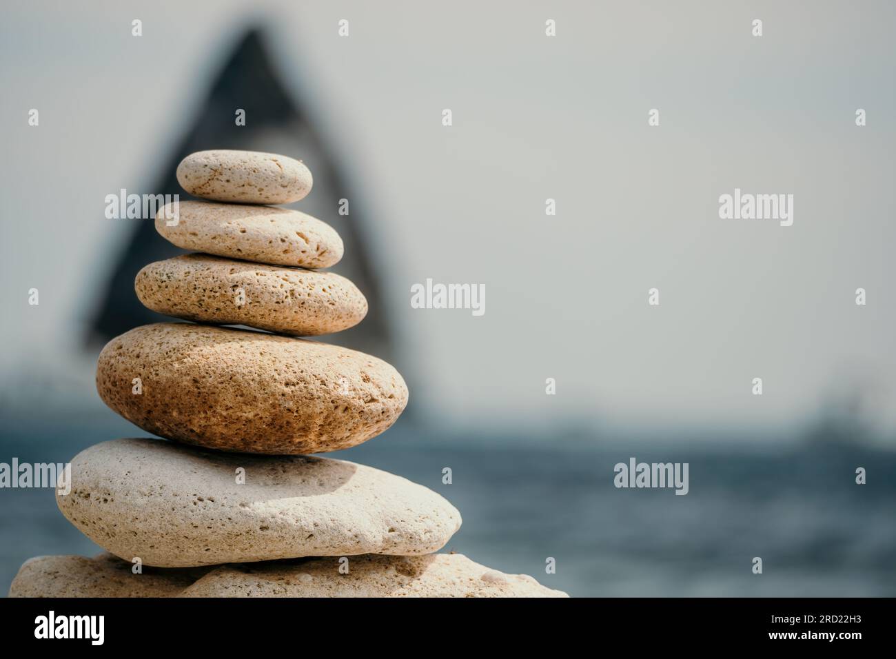 balanced rock pyramid on the pebbled beach is a study in harmony and ...