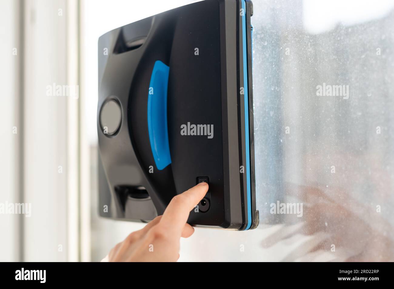 Modern window washer robot performs work on a dirty window. Cleaning ...