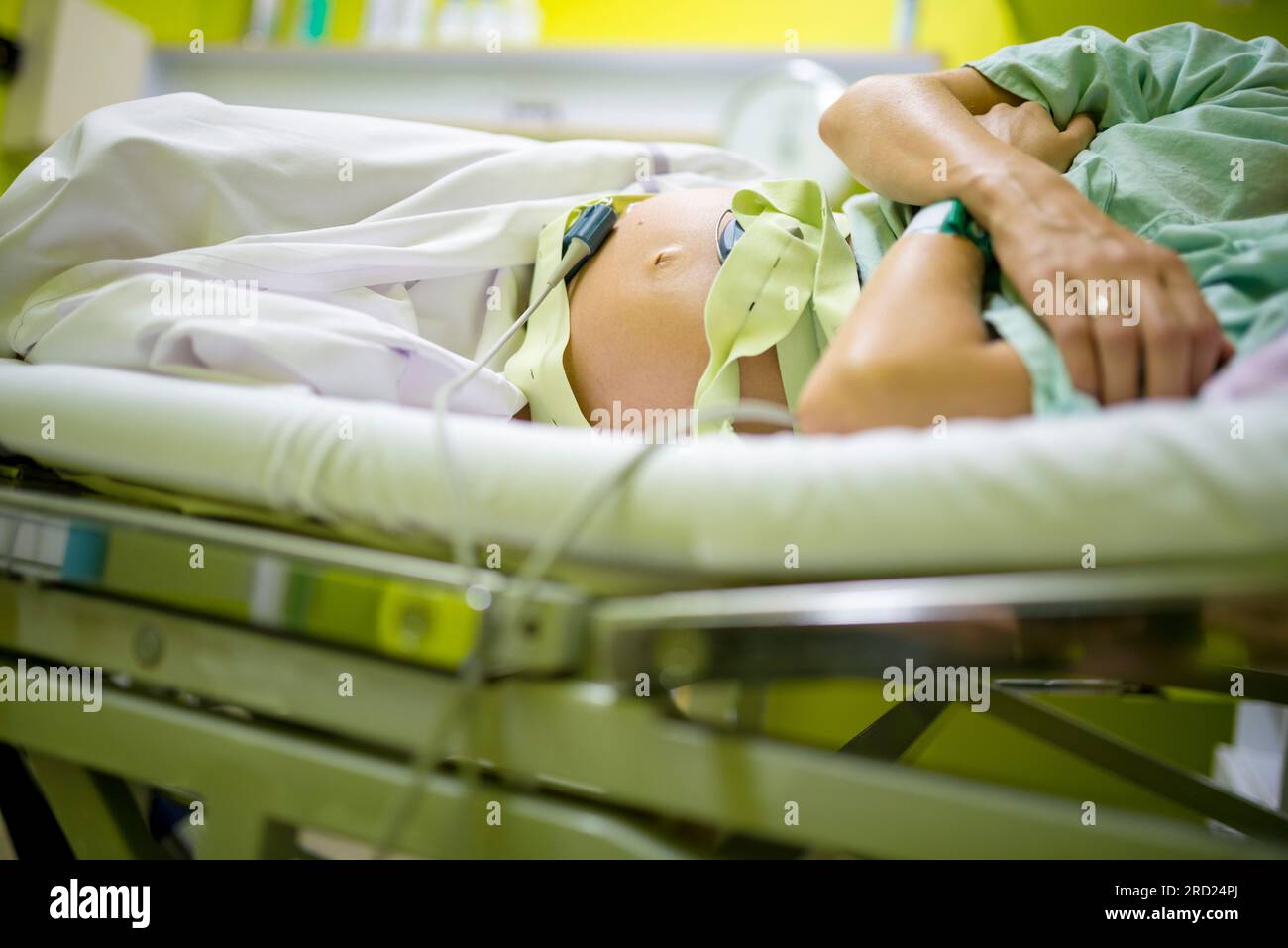 Low angle view of a pregnant woman lying in a hospital bed with baby ...