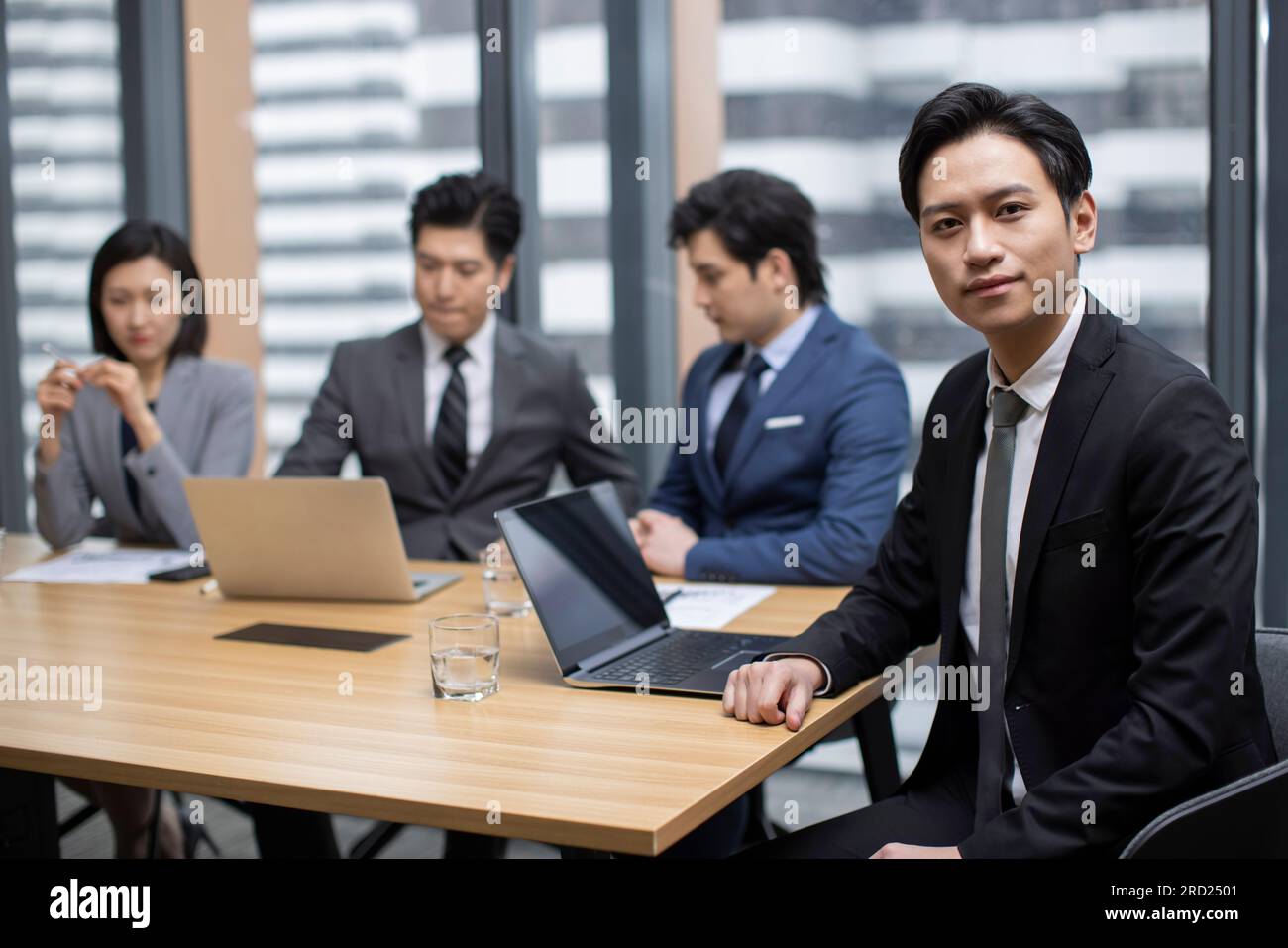 Confident Chinese business people having a meeting Stock Photo - Alamy