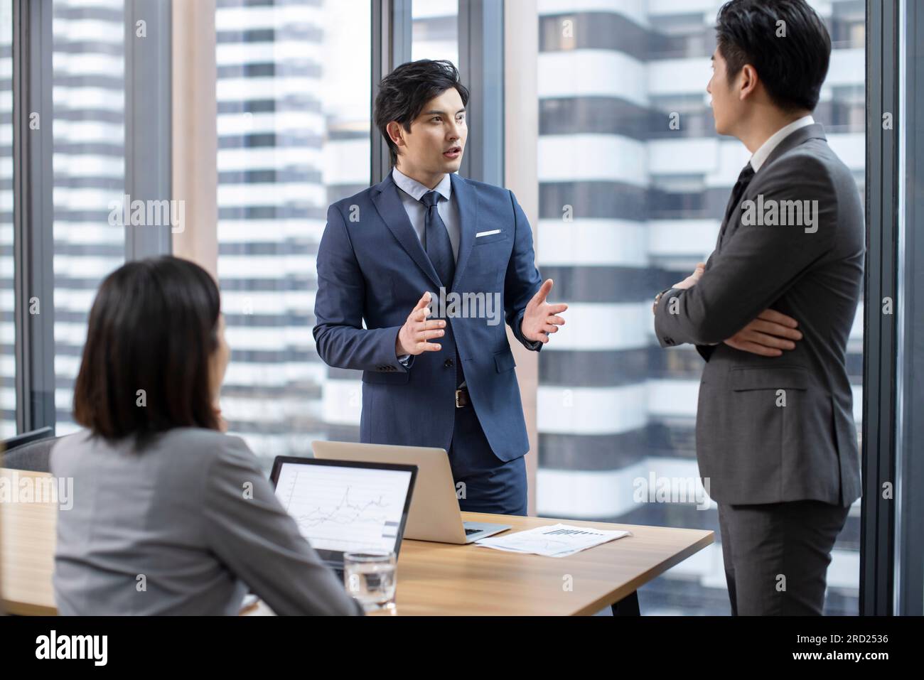 Confident Chinese business people having a meeting Stock Photo - Alamy