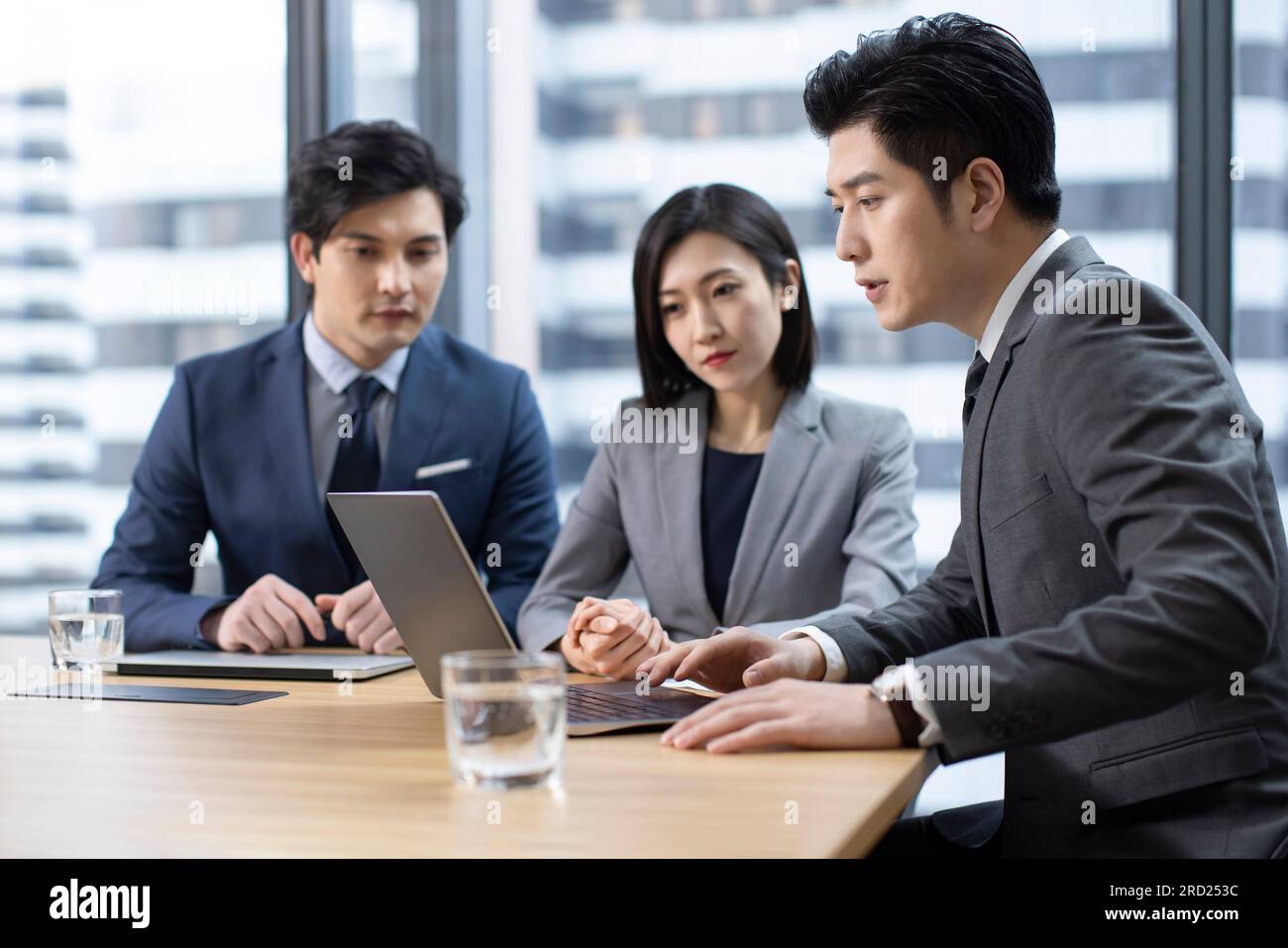 Confident Chinese business people having a meeting Stock Photo - Alamy