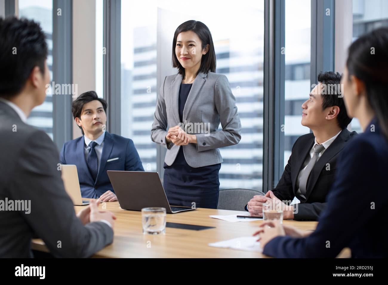 Confident Chinese business people having a meeting Stock Photo - Alamy