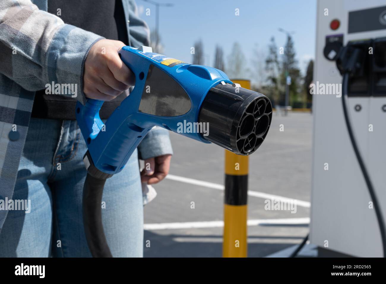 Woman holding fast charging socket CHAdeMO. Connector plug for electric ...