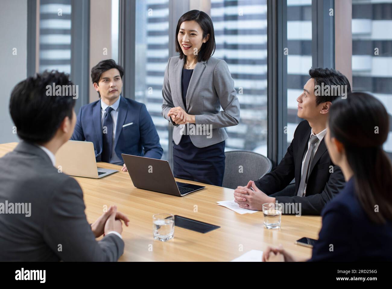 Confident Chinese business people having a meeting Stock Photo - Alamy