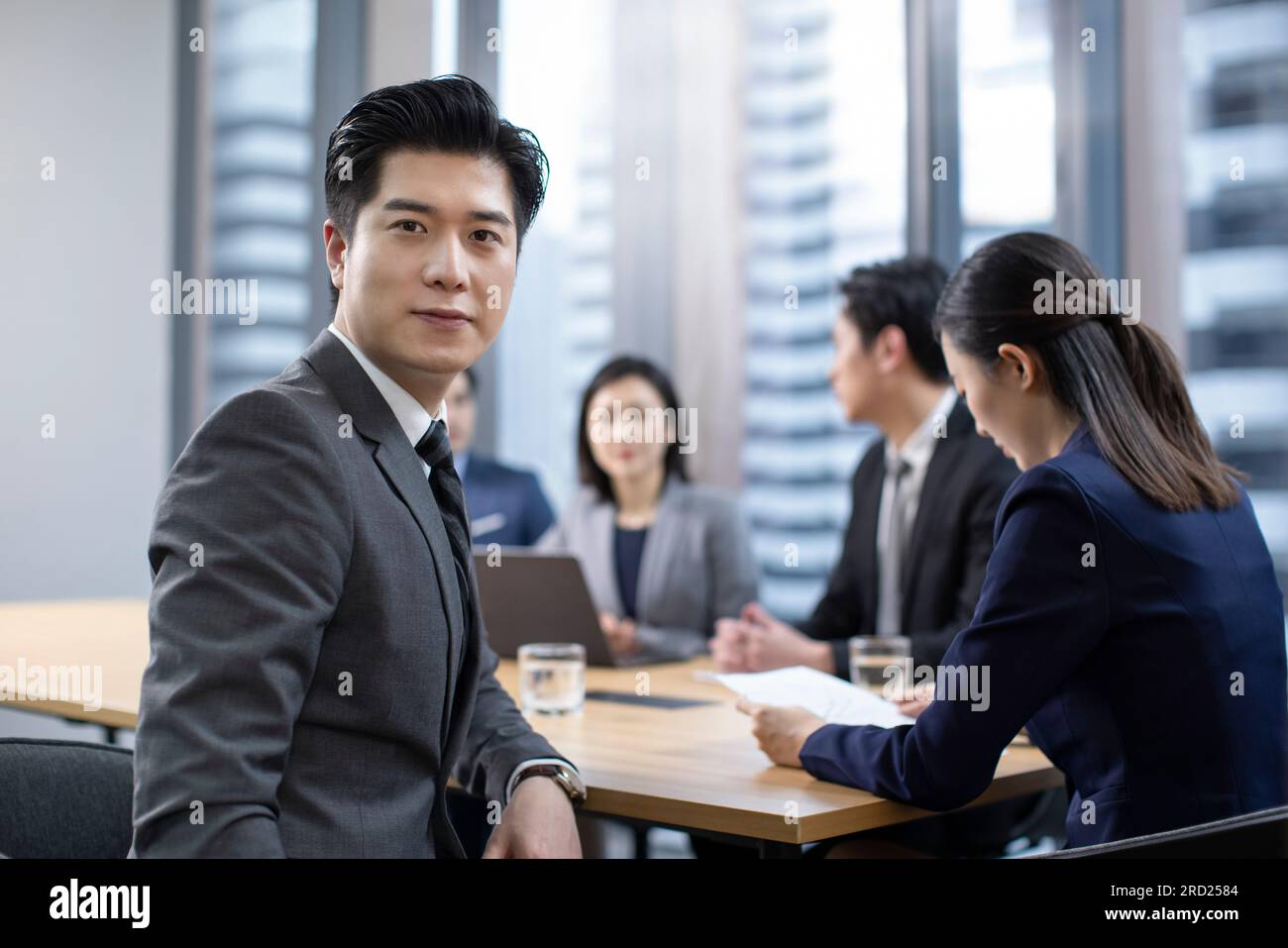 Confident Chinese business people having a meeting Stock Photo - Alamy