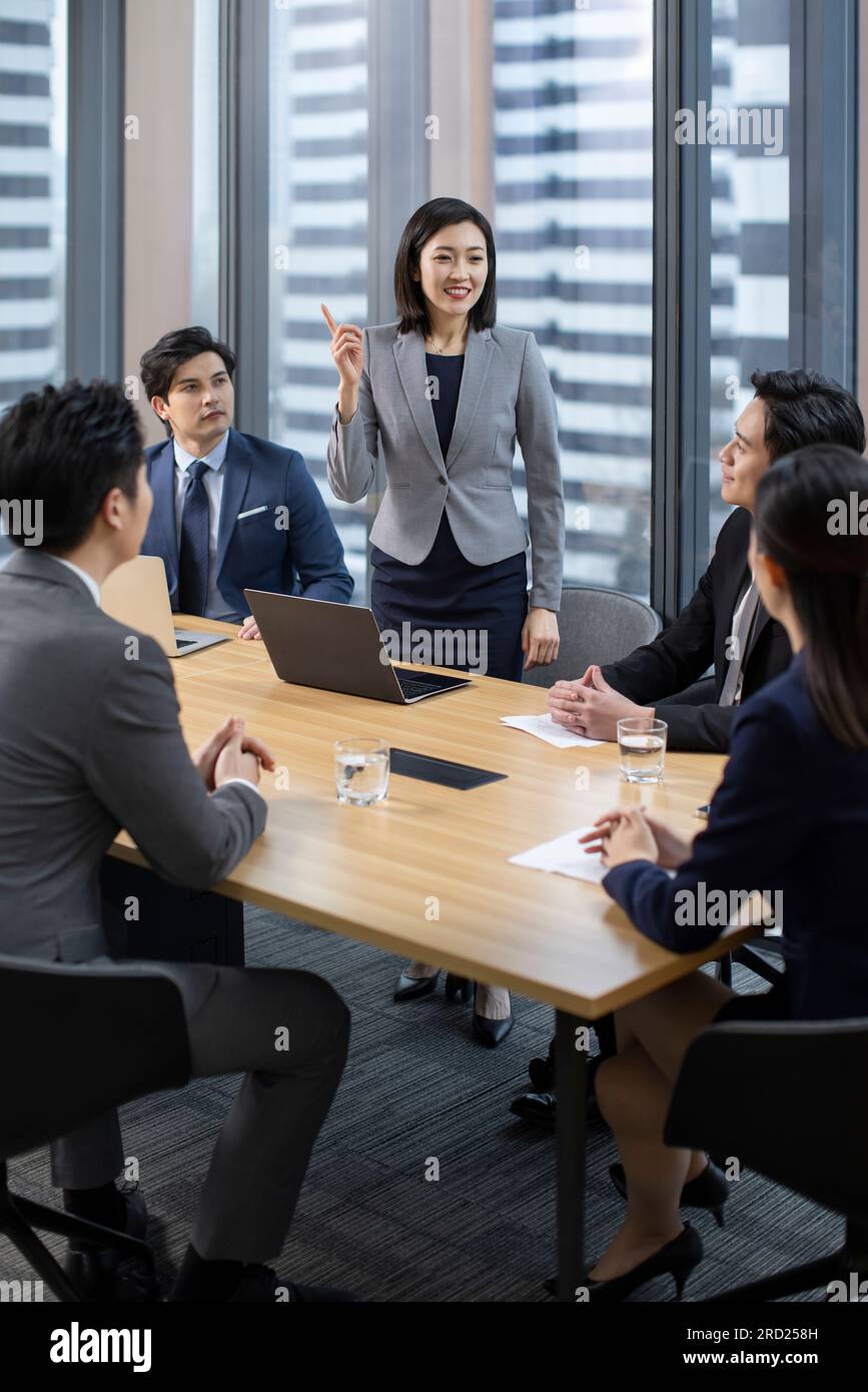 Confident Chinese business people having a meeting Stock Photo - Alamy
