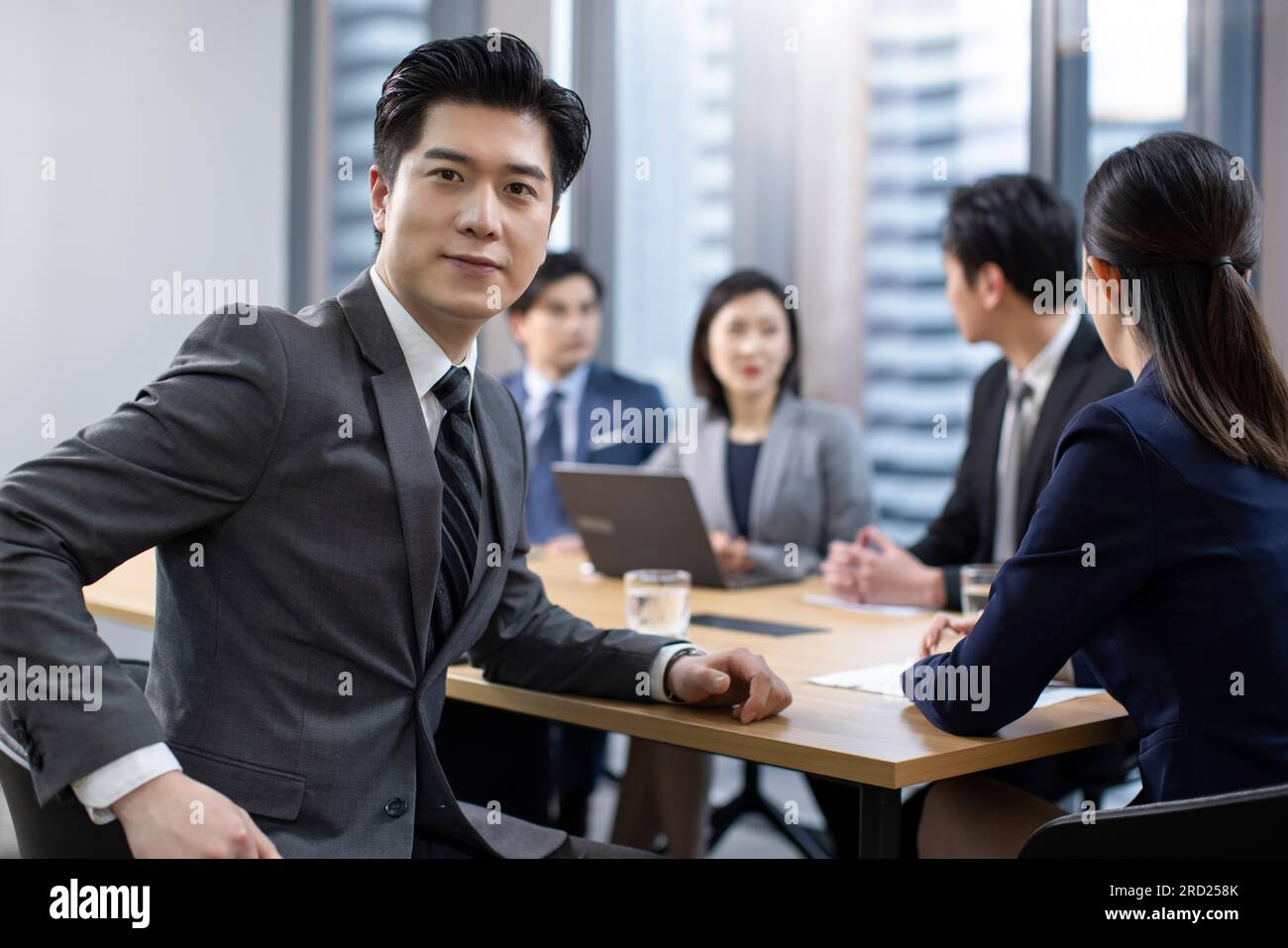 Confident Chinese business people having a meeting Stock Photo - Alamy