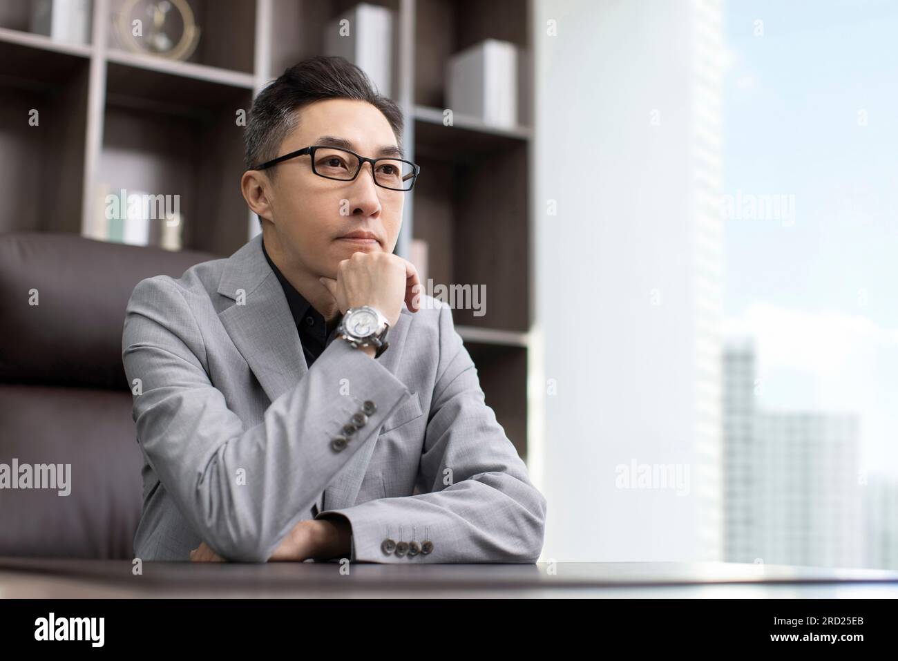 Successful Chinese businessman thinking in office Stock Photo - Alamy