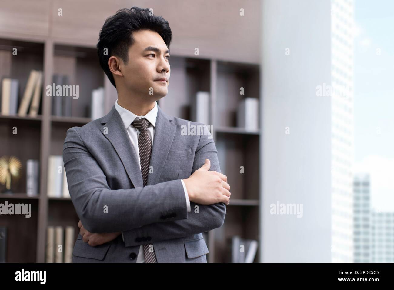 Successful Chinese businessman thinking in office Stock Photo - Alamy
